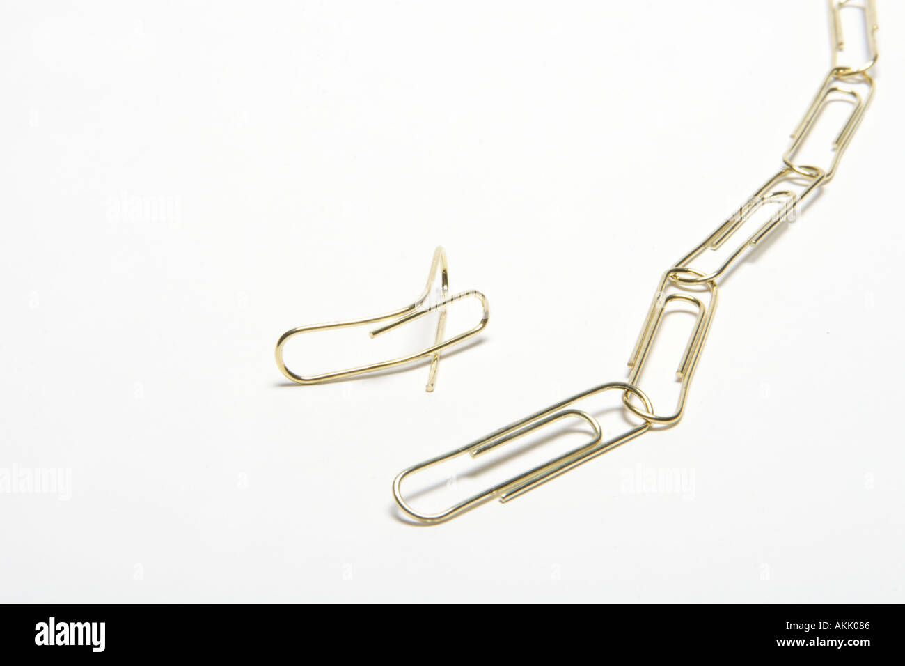 Many Gold coloured paperclips linked together on white background Stock ...