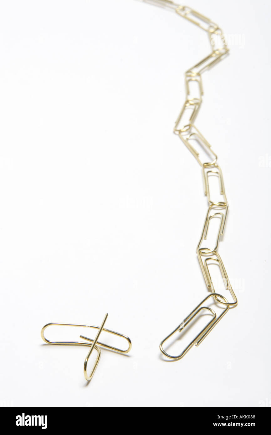 Many Gold coloured paperclips linked together on white background Stock ...