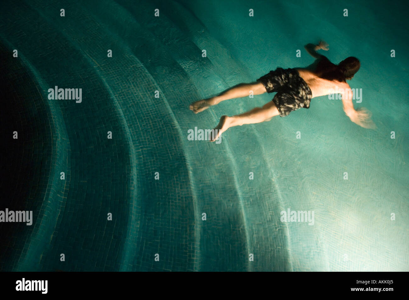 Man swimming underwater in pool Stock Photo - Alamy