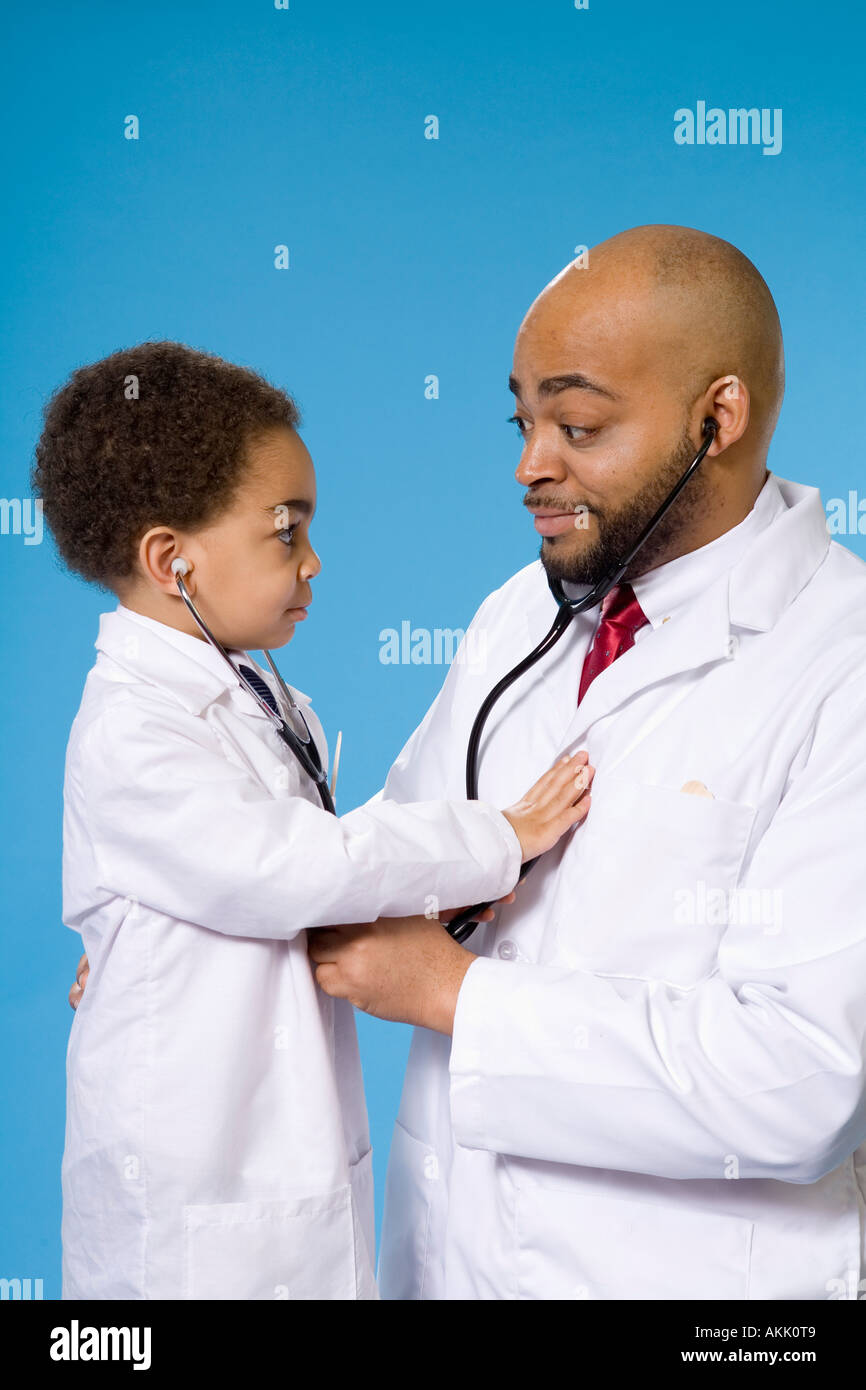 Profile of male doctor and young boy Stock Photo - Alamy