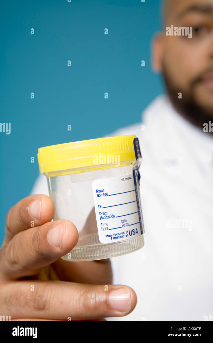 Close up of male doctor’s hand holding container Stock Photo - Alamy