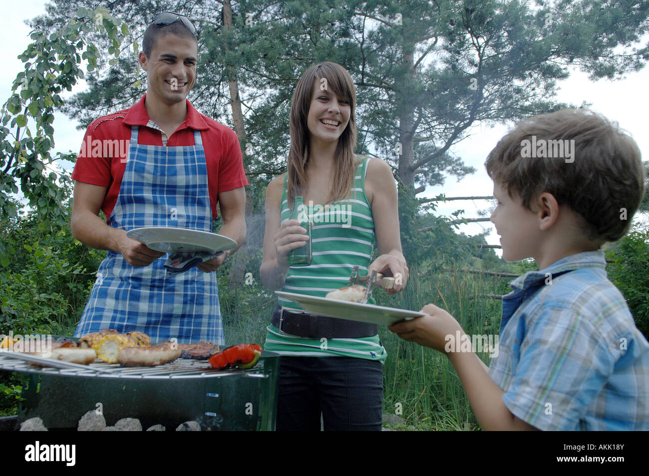 young people having a barbecue Stock Photo - Alamy