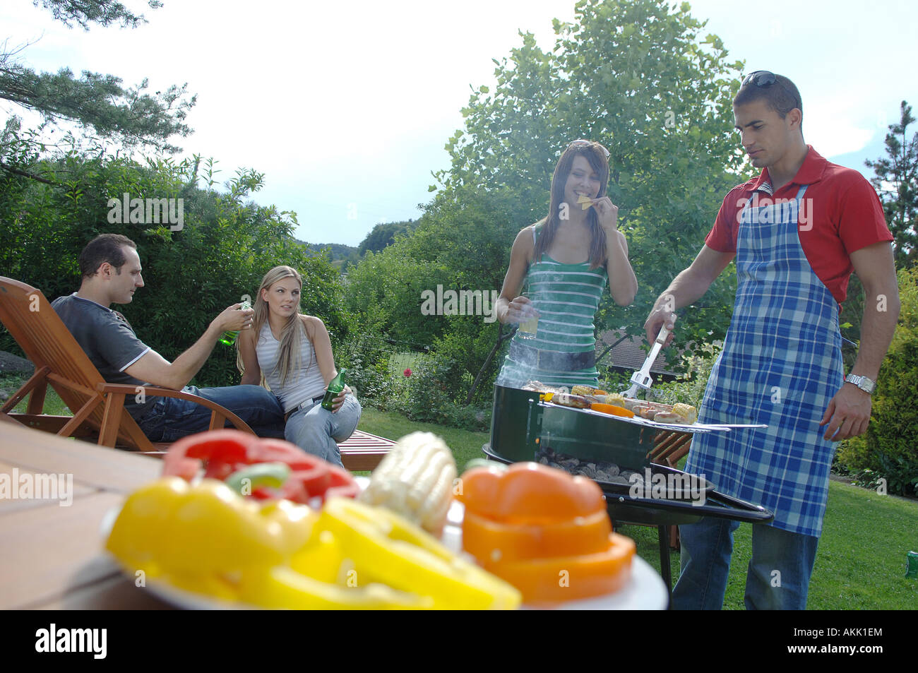 young people having a barbecue Stock Photo - Alamy