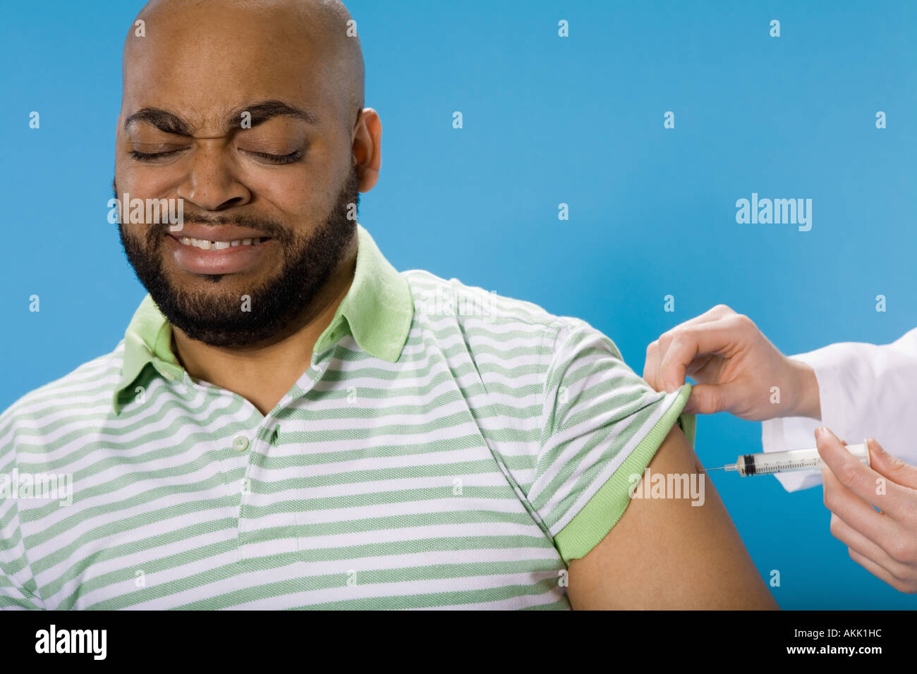 Man receiving injection in the arm Stock Photo - Alamy