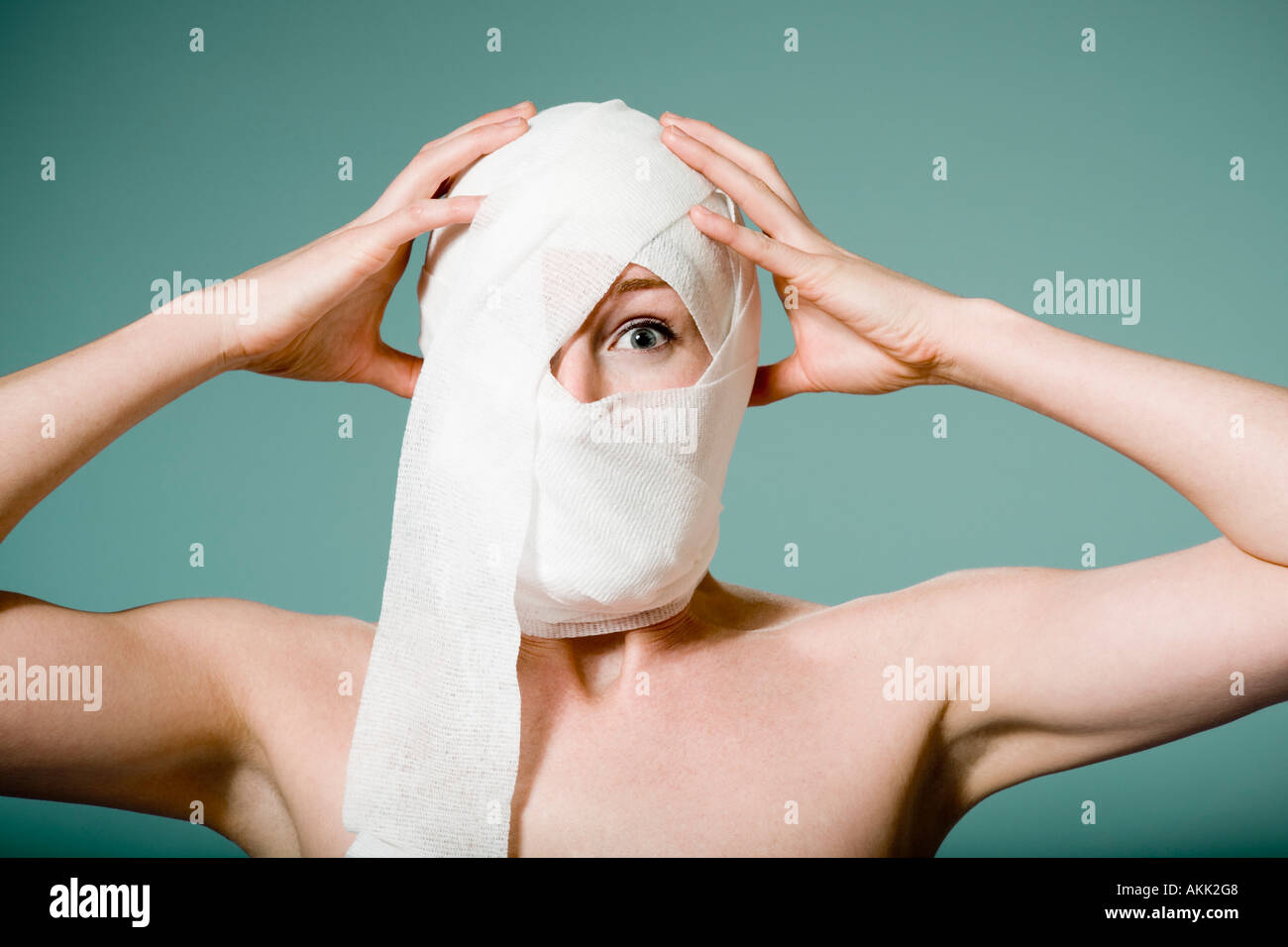 Woman with head wrapped in bandage Stock Photo - Alamy
