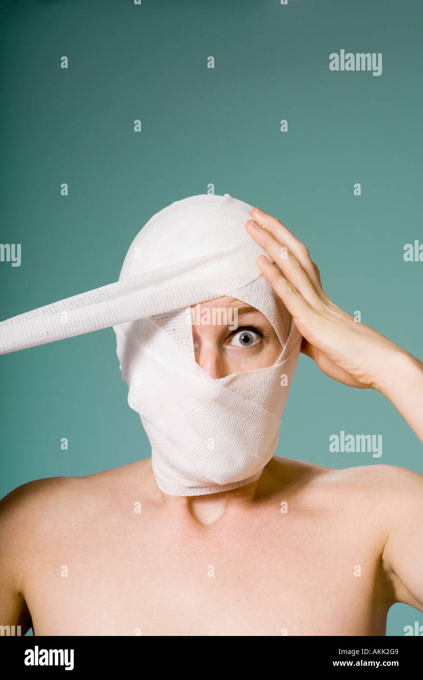 Woman with head wrapped in bandage Stock Photo - Alamy