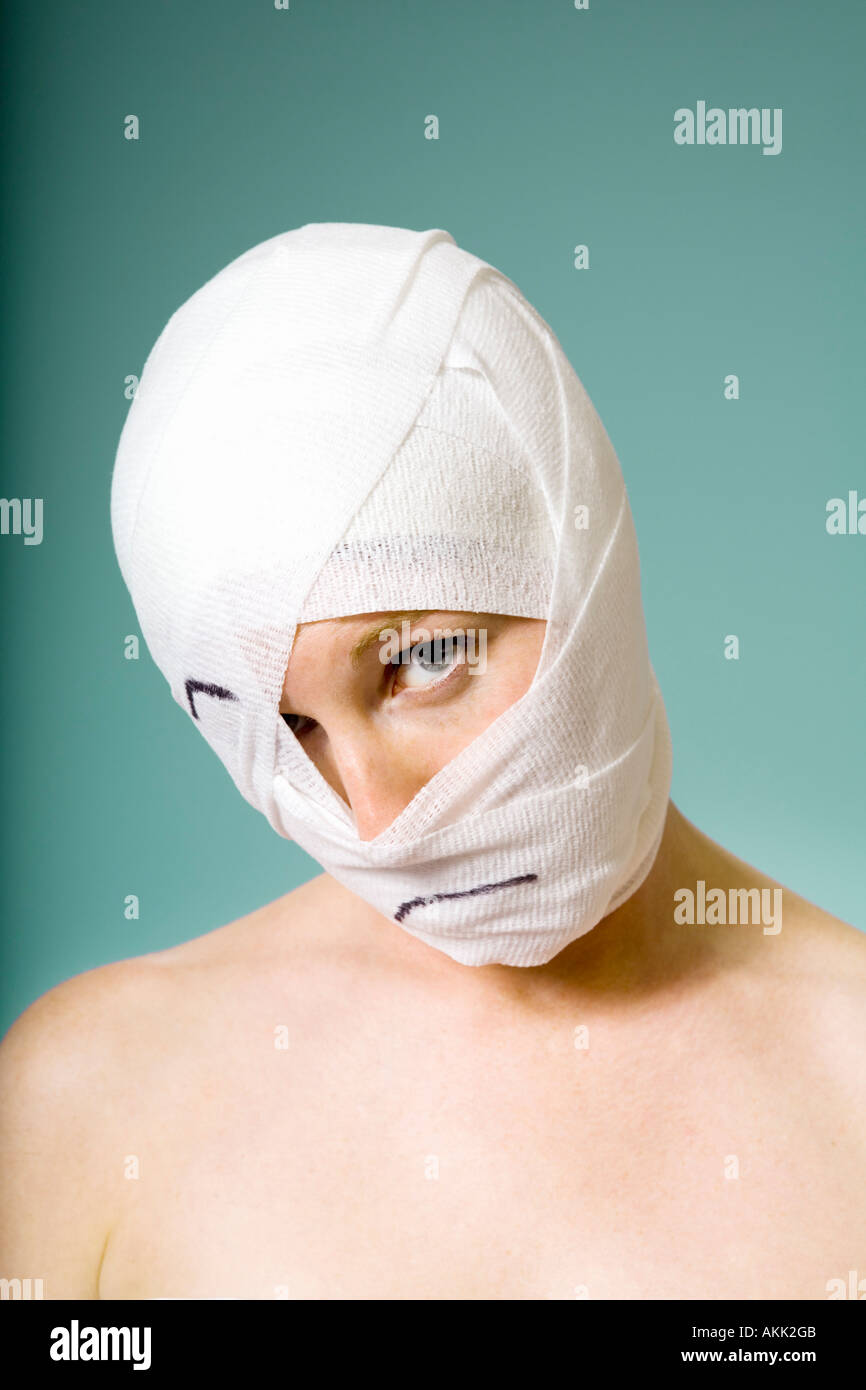Woman with head wrapped in bandage Stock Photo - Alamy