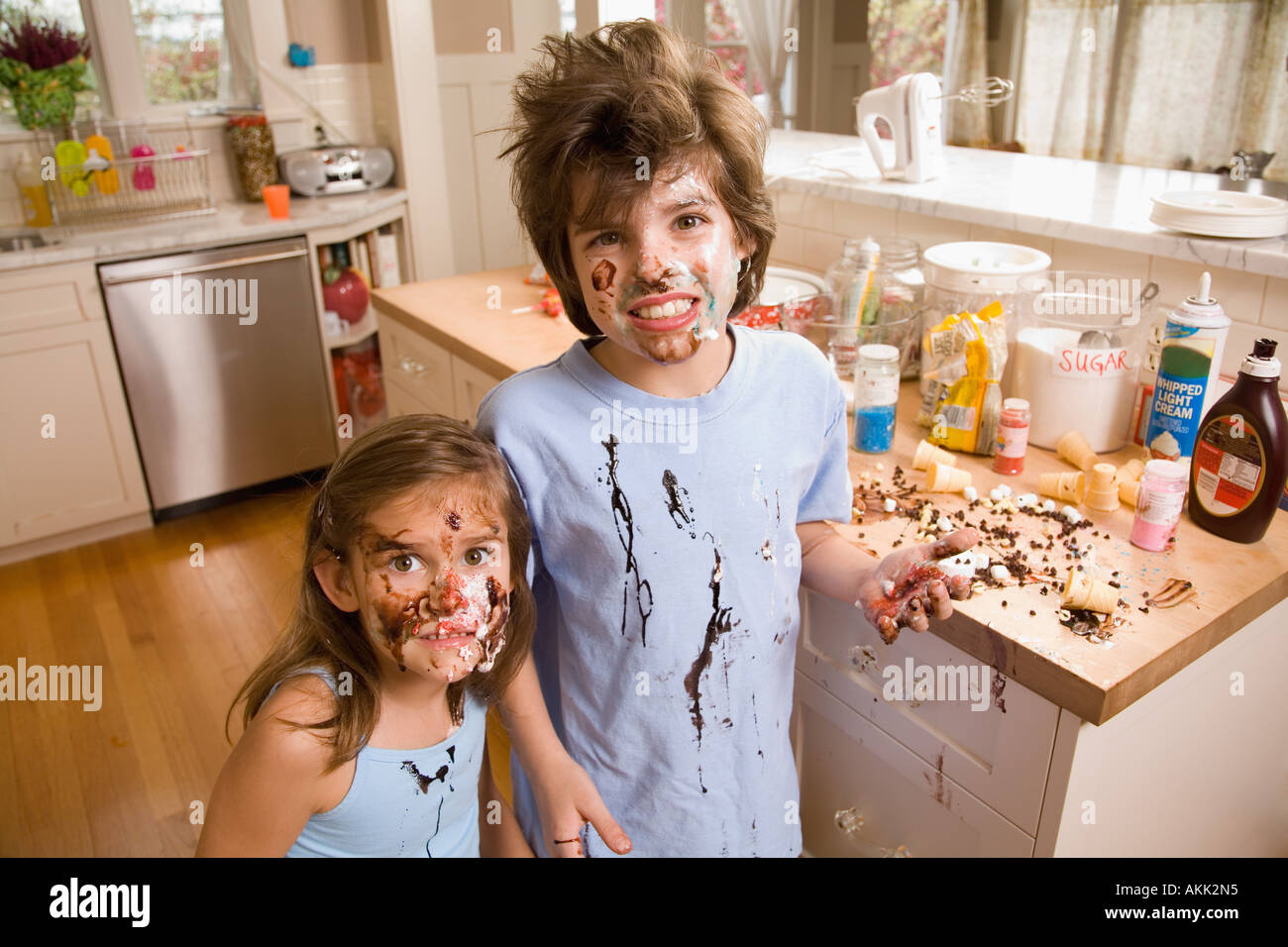 Portrait of brother and sister with food on face Stock Photo - Alamy