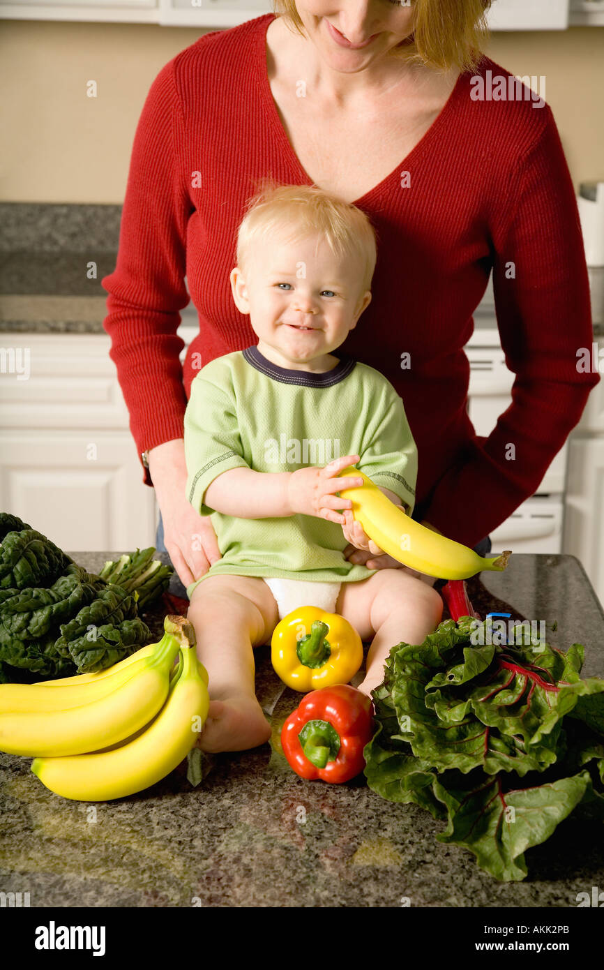 Portrait of young boy sitting on kitchen counter Stock Photo - Alamy