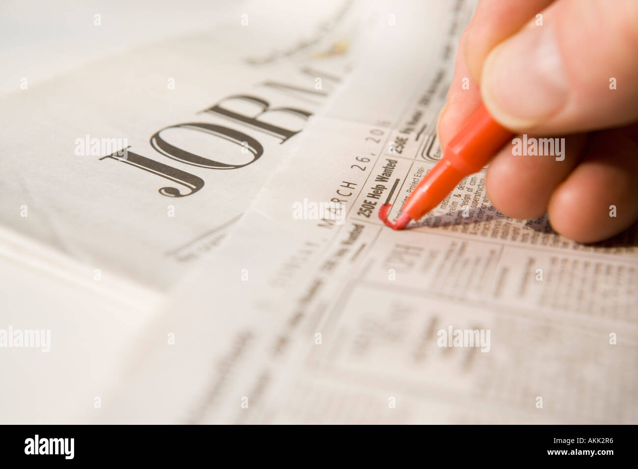 Hand circling ad in paper Stock Photo - Alamy