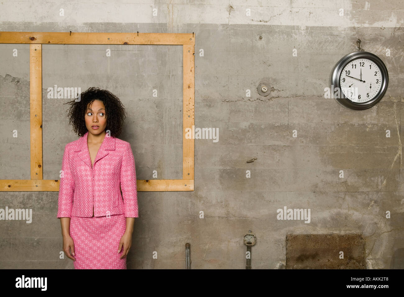 Woman standing by wall hi-res stock photography and images - Alamy