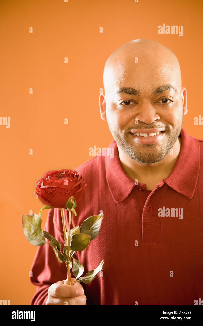 Portrait of man holding rose Stock Photo - Alamy