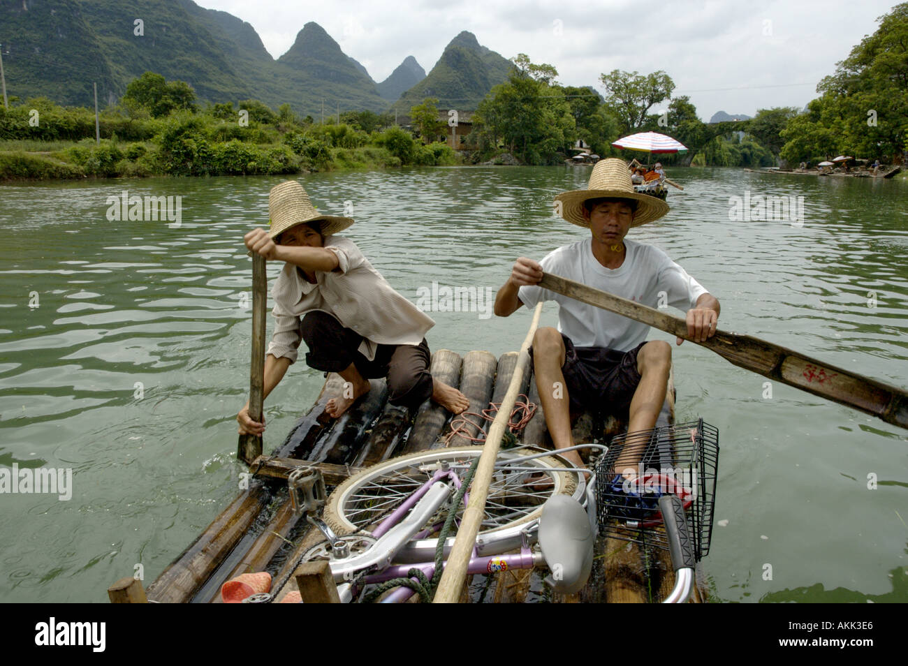 China Guangxi Yangshuo A Chinese Couple Rowing On A Bamboo Raft On The ...