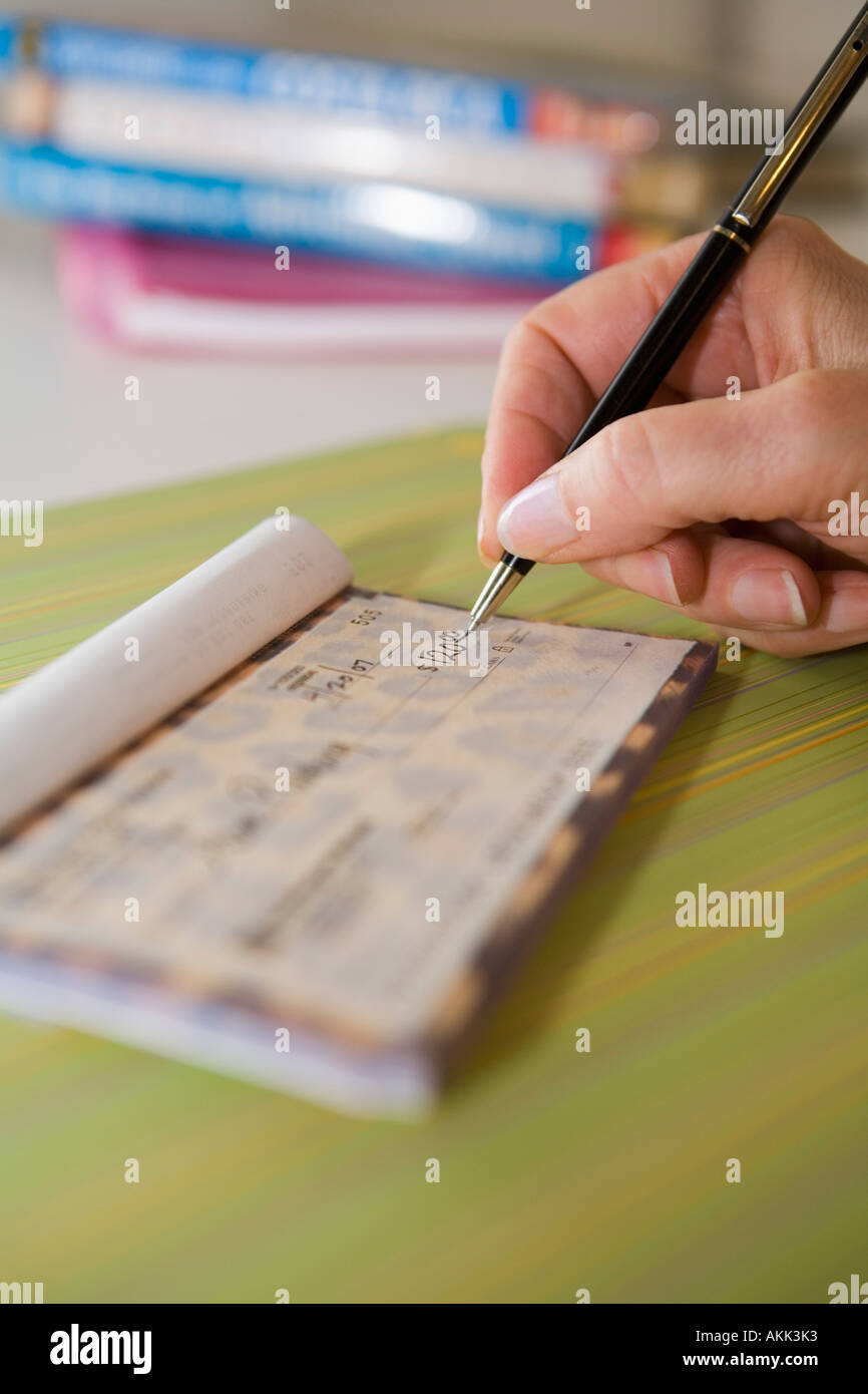 Hand writing check Stock Photo - Alamy