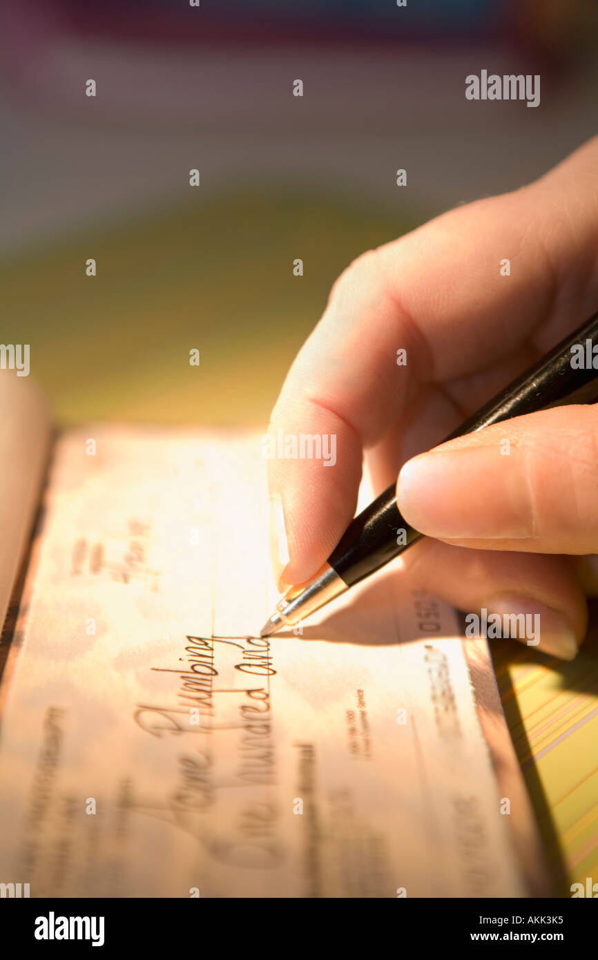Hand writing check Stock Photo - Alamy