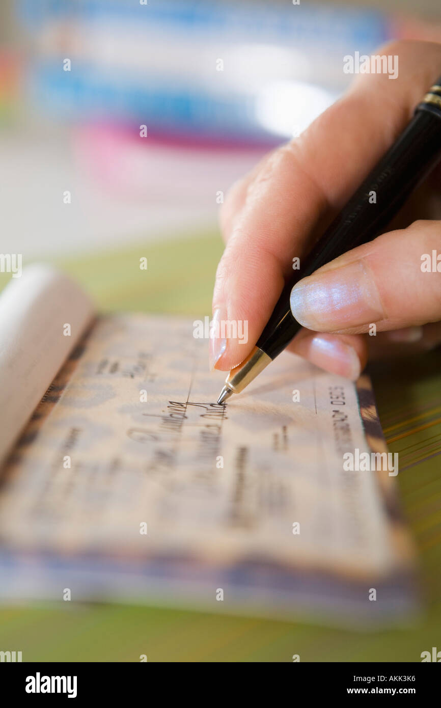Hand writing check Stock Photo - Alamy