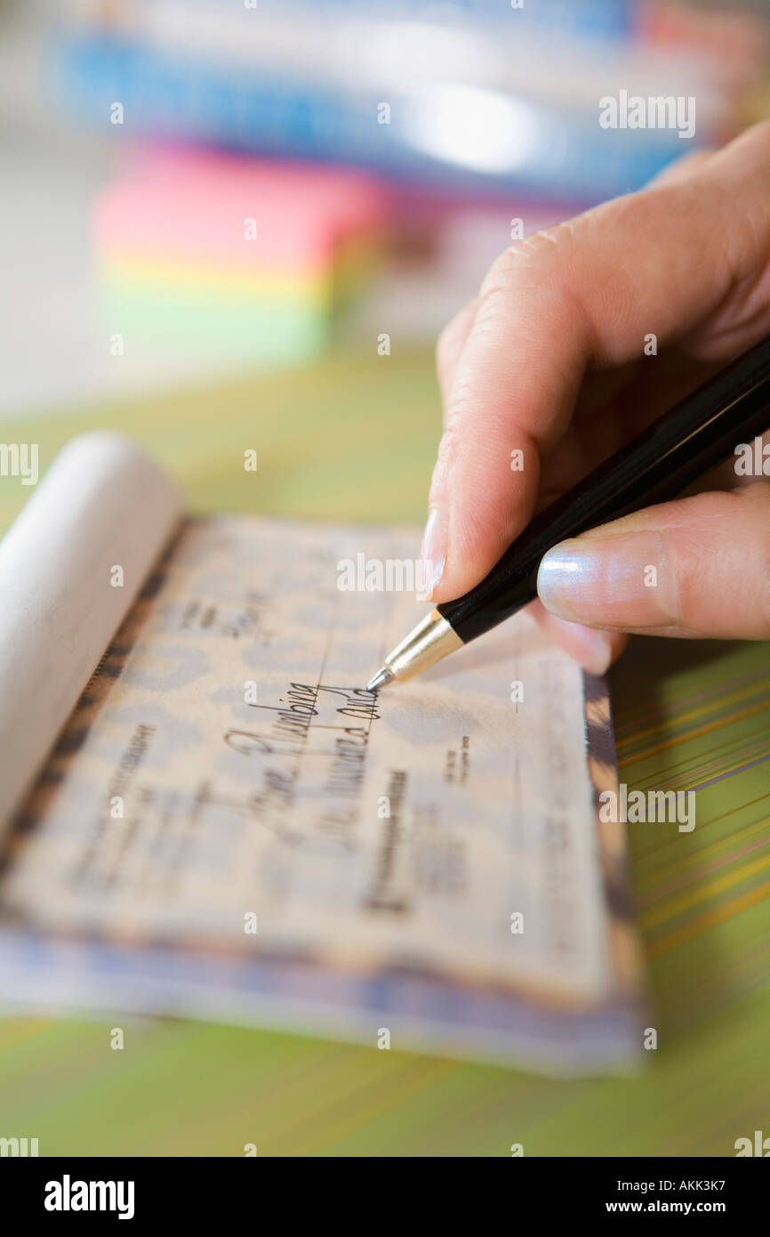 Hand writing check Stock Photo - Alamy
