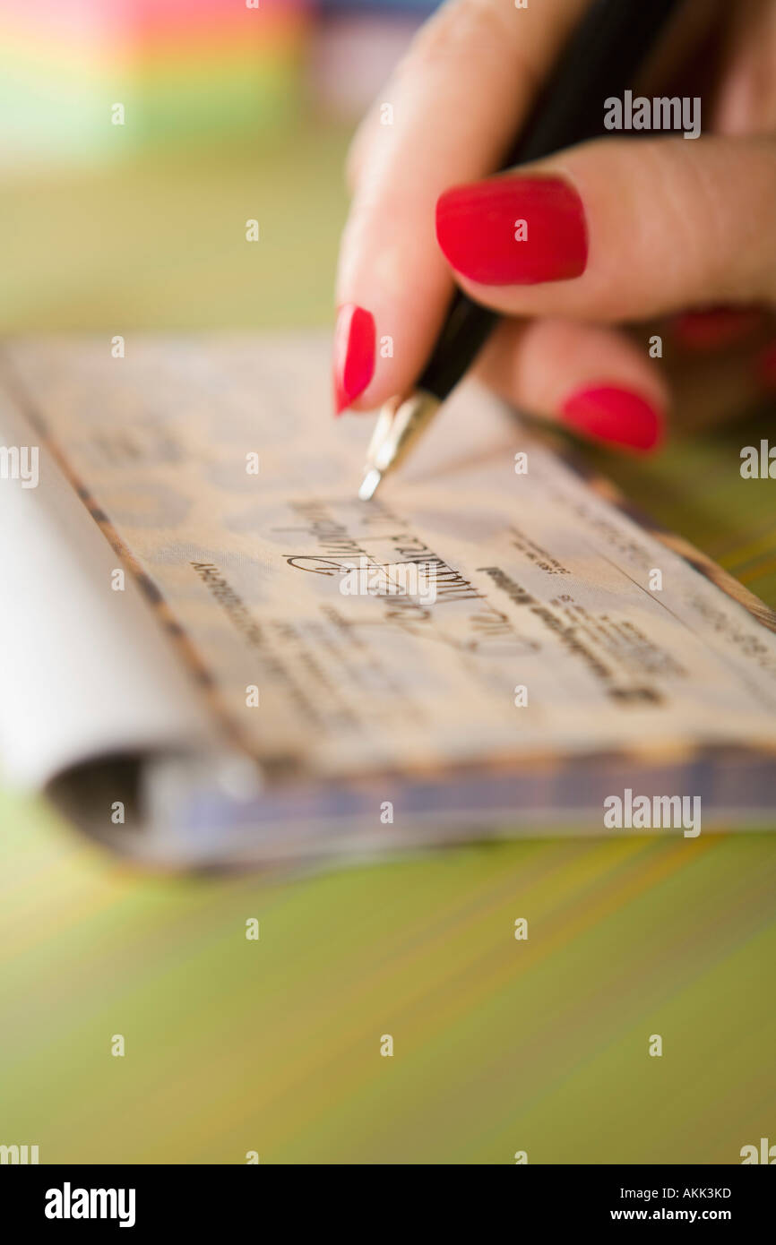 Hand writing check Stock Photo - Alamy