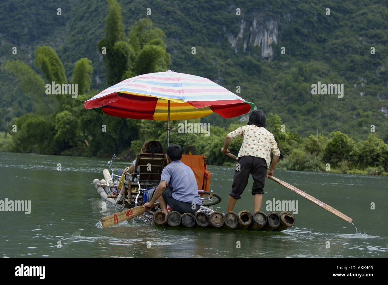 China Guangxi Yangshuo A Chinese Couple Rowing On A Bamboo Raft On The ...
