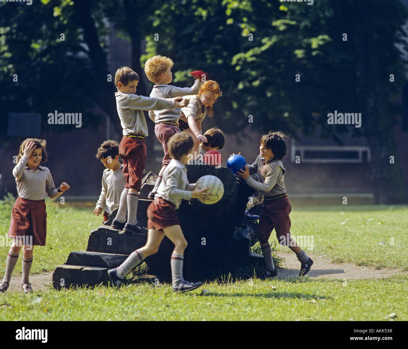 Children playing on a rock Kensington Gardens London England Stock ...
