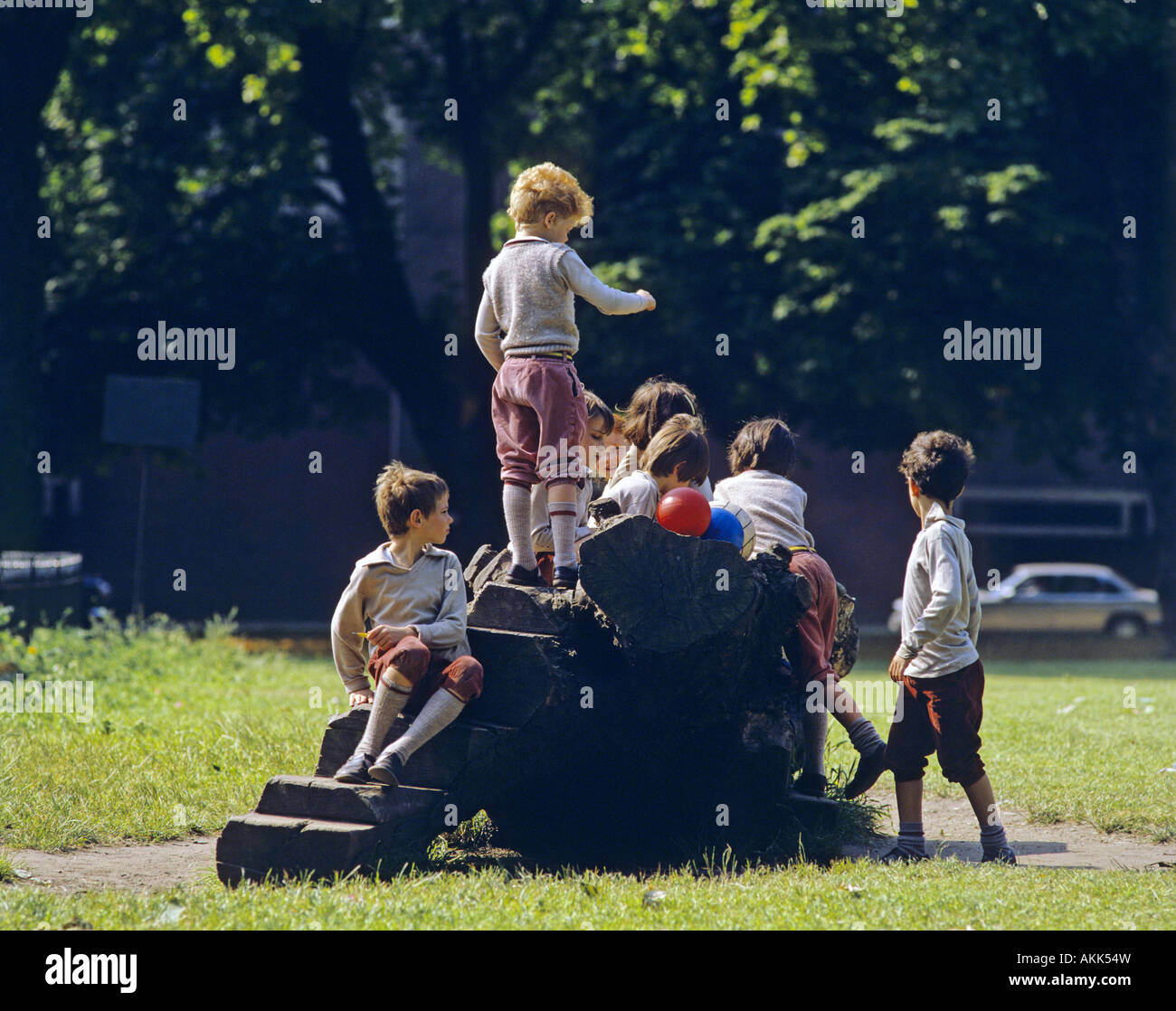 Children playing on a rock Kensington Gardens London England Stock ...