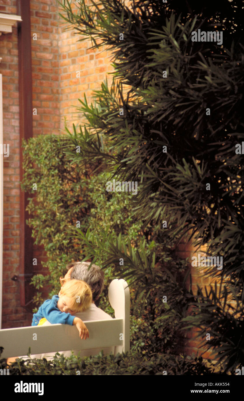 Sleeping child with father on bench Stock Photo - Alamy