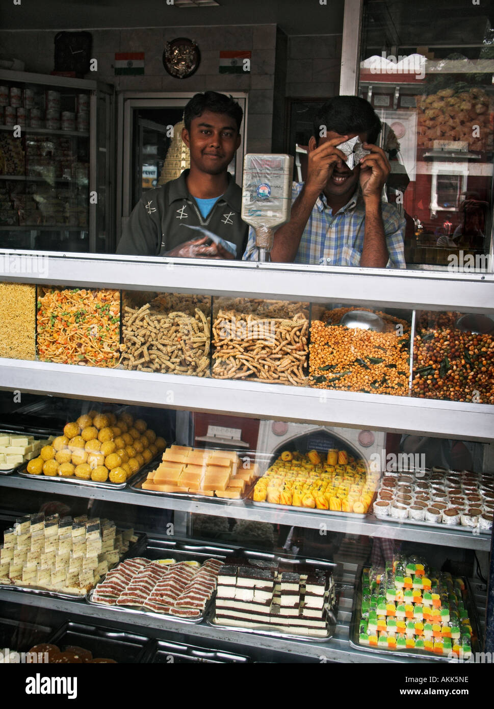 Indian men behind counter hi-res stock photography and images - Alamy