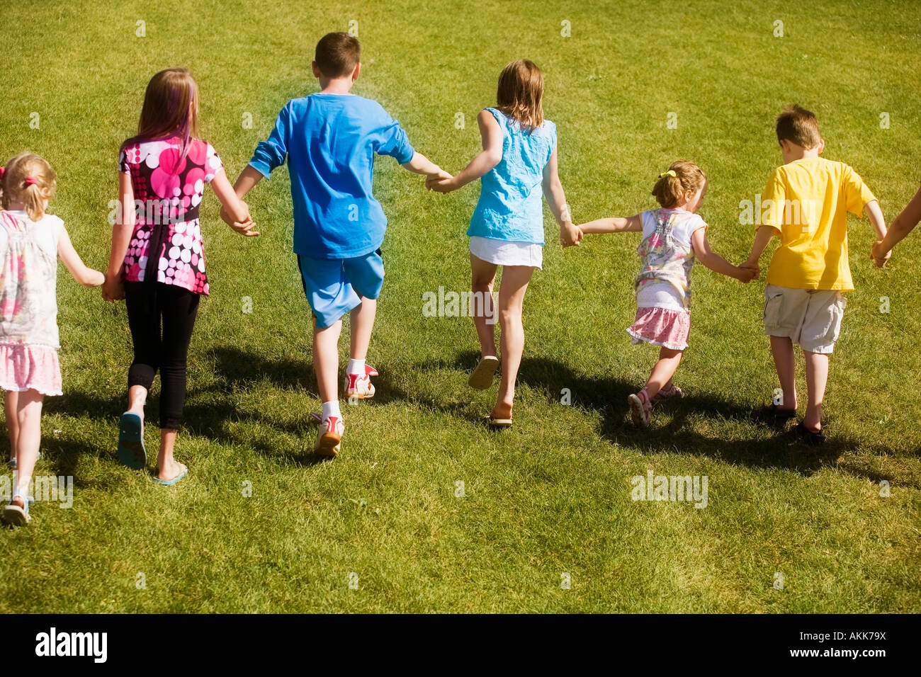 Rear view of children running Stock Photo - Alamy