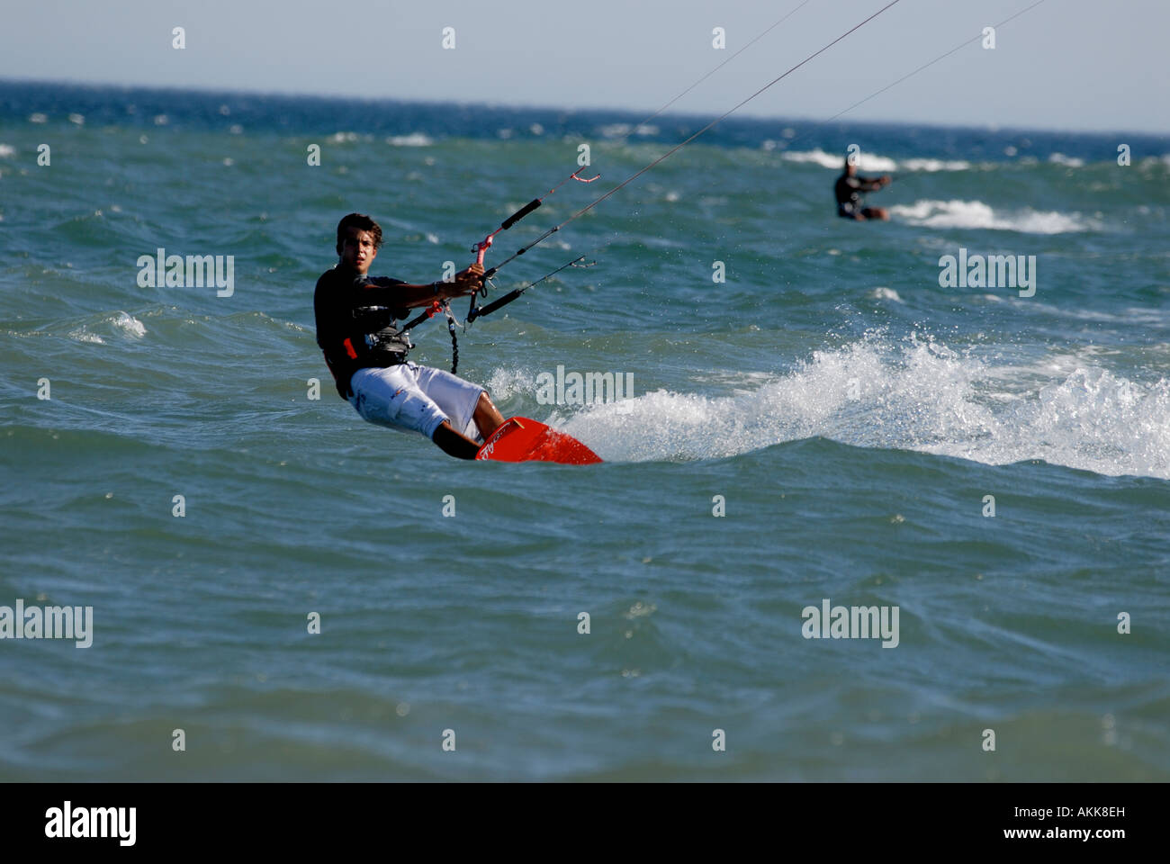 Kite surfer carving through water ploughing up wake Stock Photo - Alamy