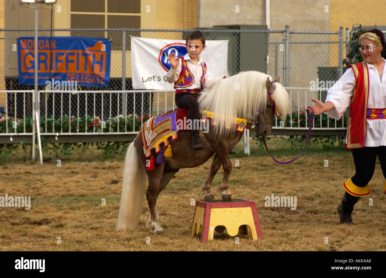Small boy riding pony in a show at the fair Stock Photo - Alamy