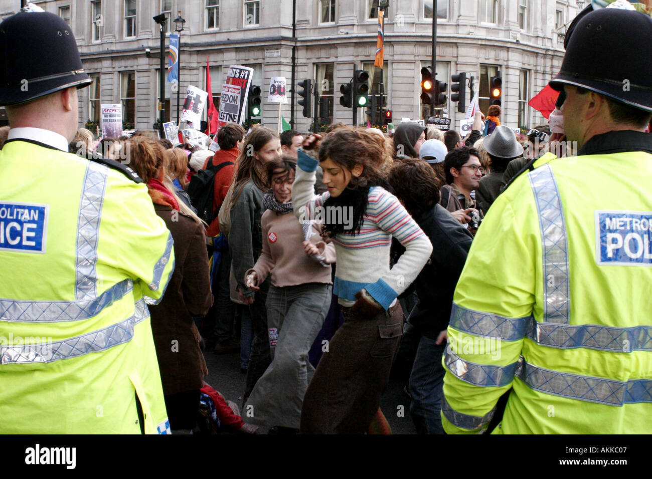 Protesters dancing freely infront of strict hands of law showing the ...