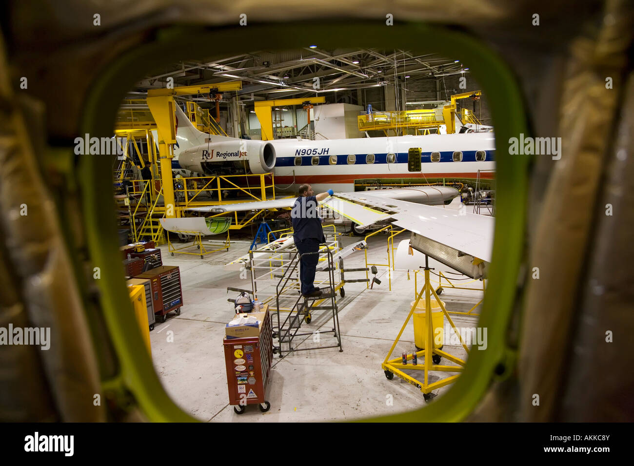 Workers do heavy maintenance on American Eagle Embraer jet airplanes at ...