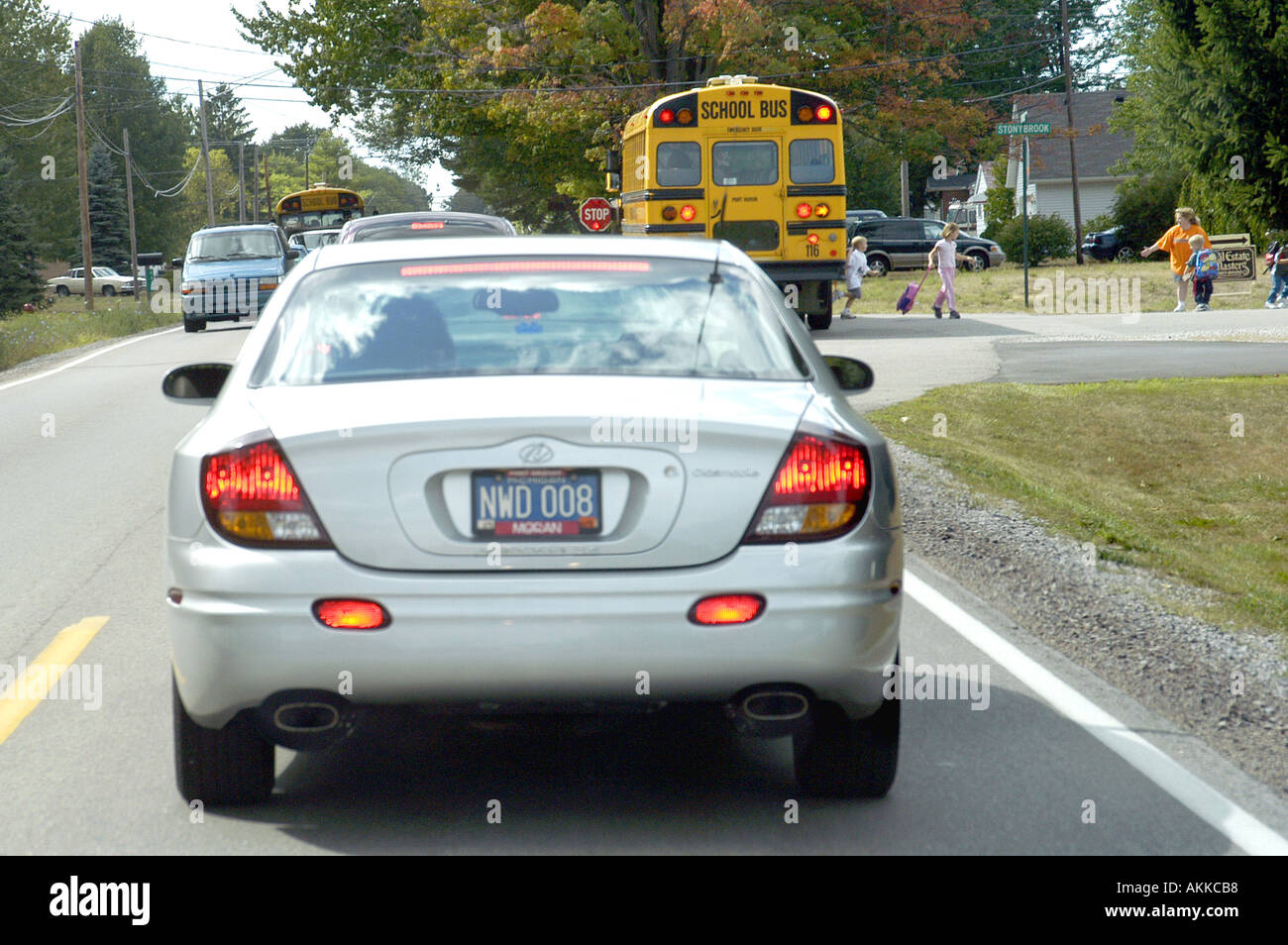 Traffic stops while school bus drops off children from school Stock ...