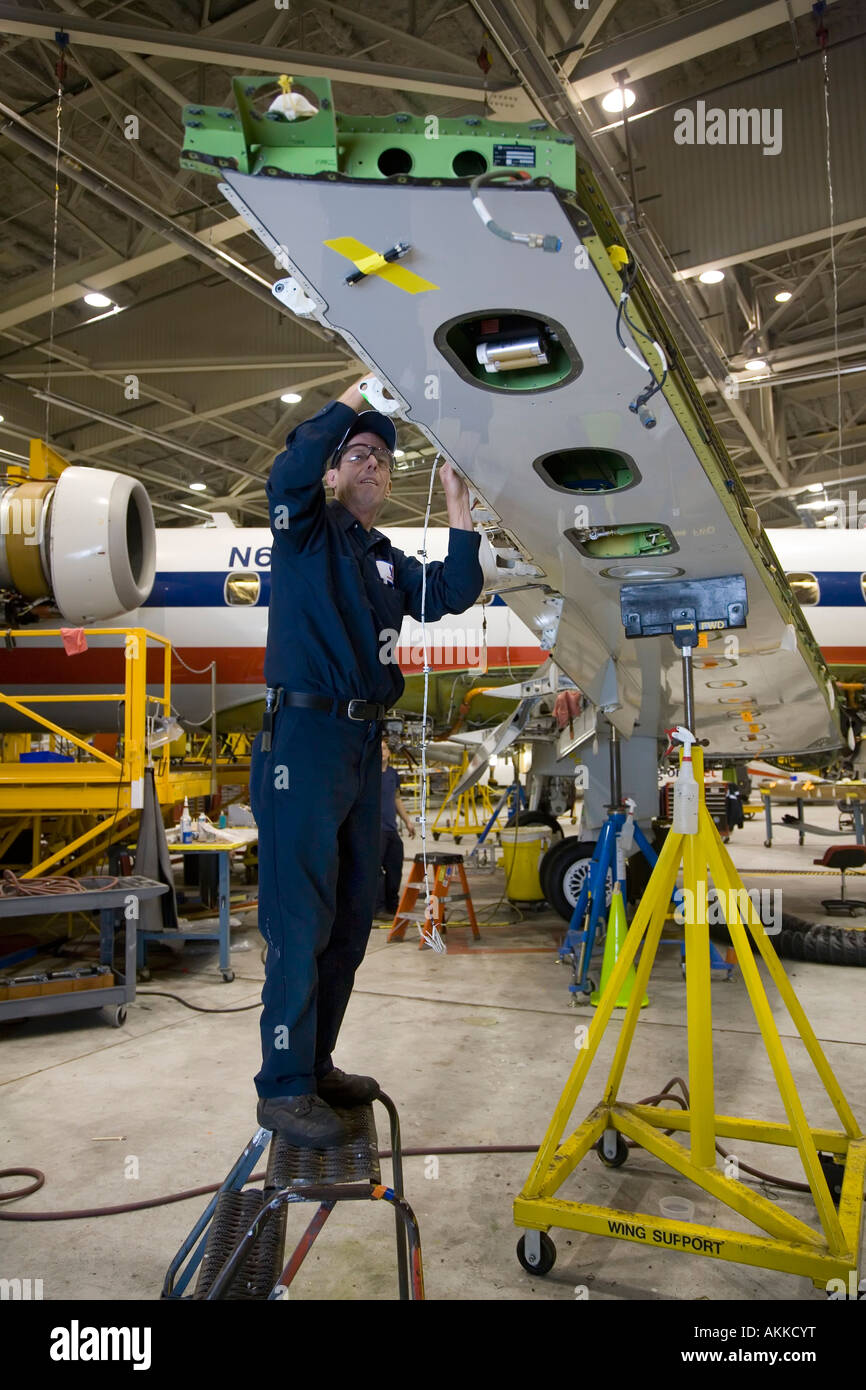 Workers do heavy maintenance on American Eagle Embraer jet airplanes at ...