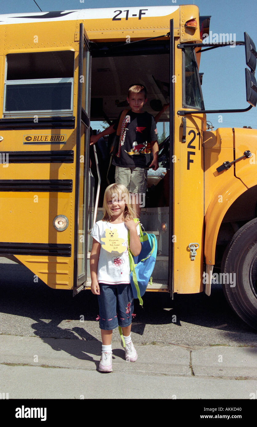 5 year old female boards a school bus on her first day at school Stock ...