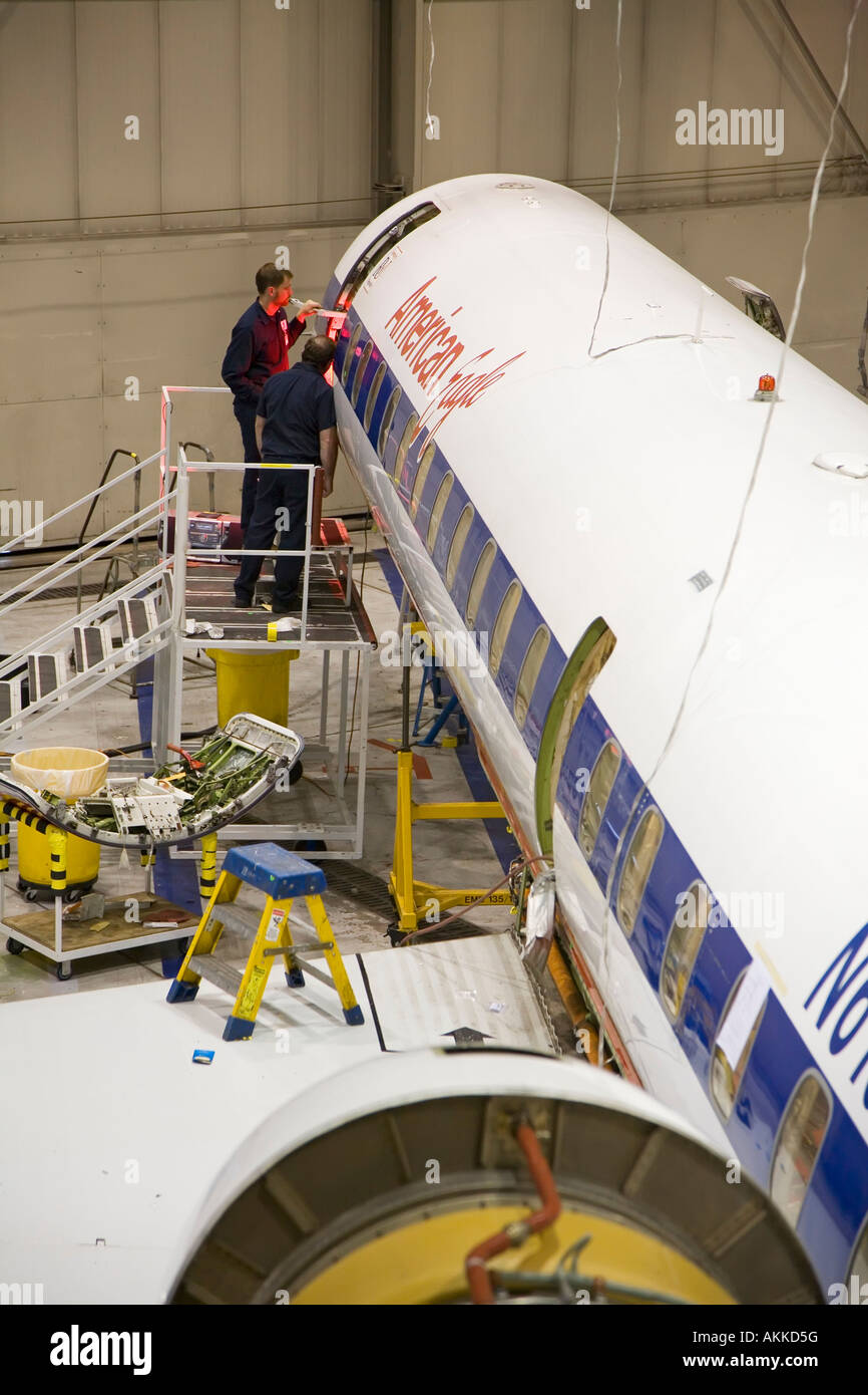Workers do heavy maintenance on American Eagle Embraer jet airplanes at ...