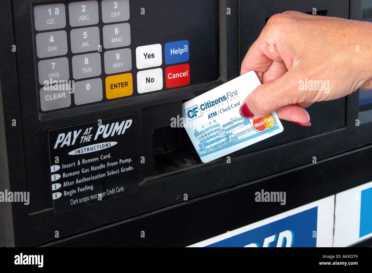Female pays at the pump for gas at a self pay and pump gas station with ...