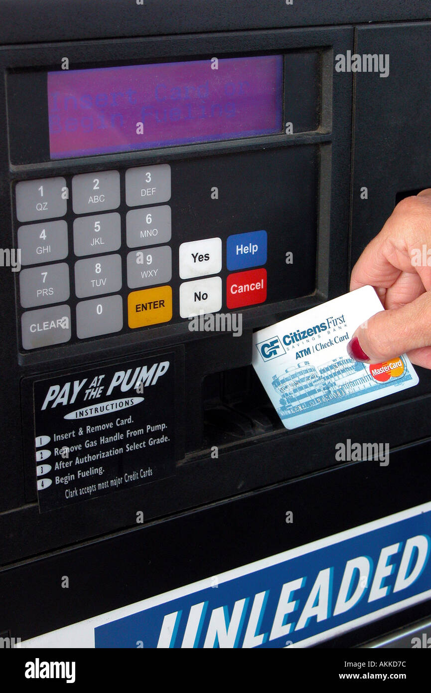 Female pays at the pump for gas at a self pay and pump gas station with ...
