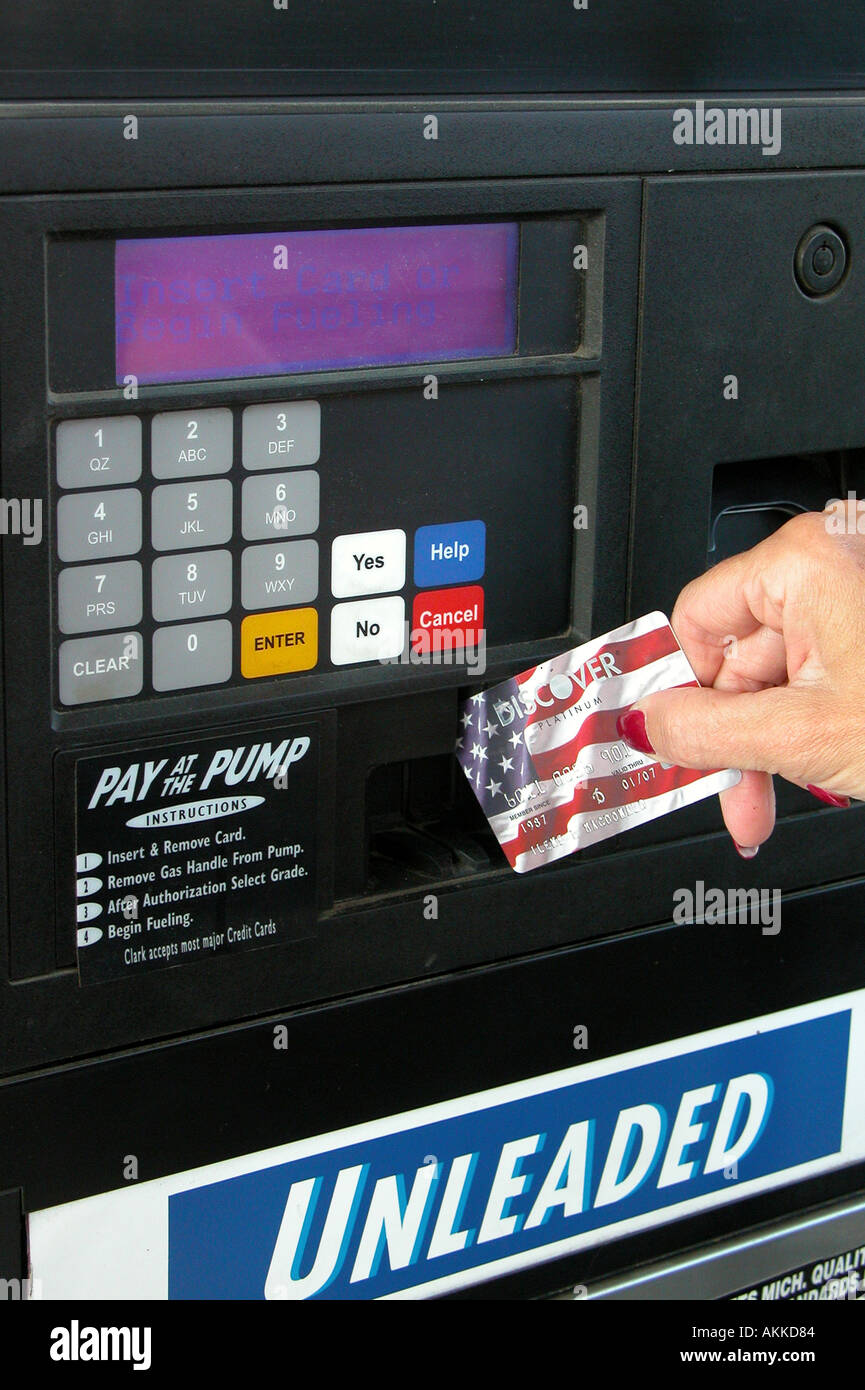 Female pays at the pump for gas at a self pay and pump gas station with ...