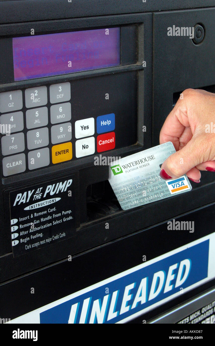 Female pays at the pump for gas at a self pay and pump gas station with ...