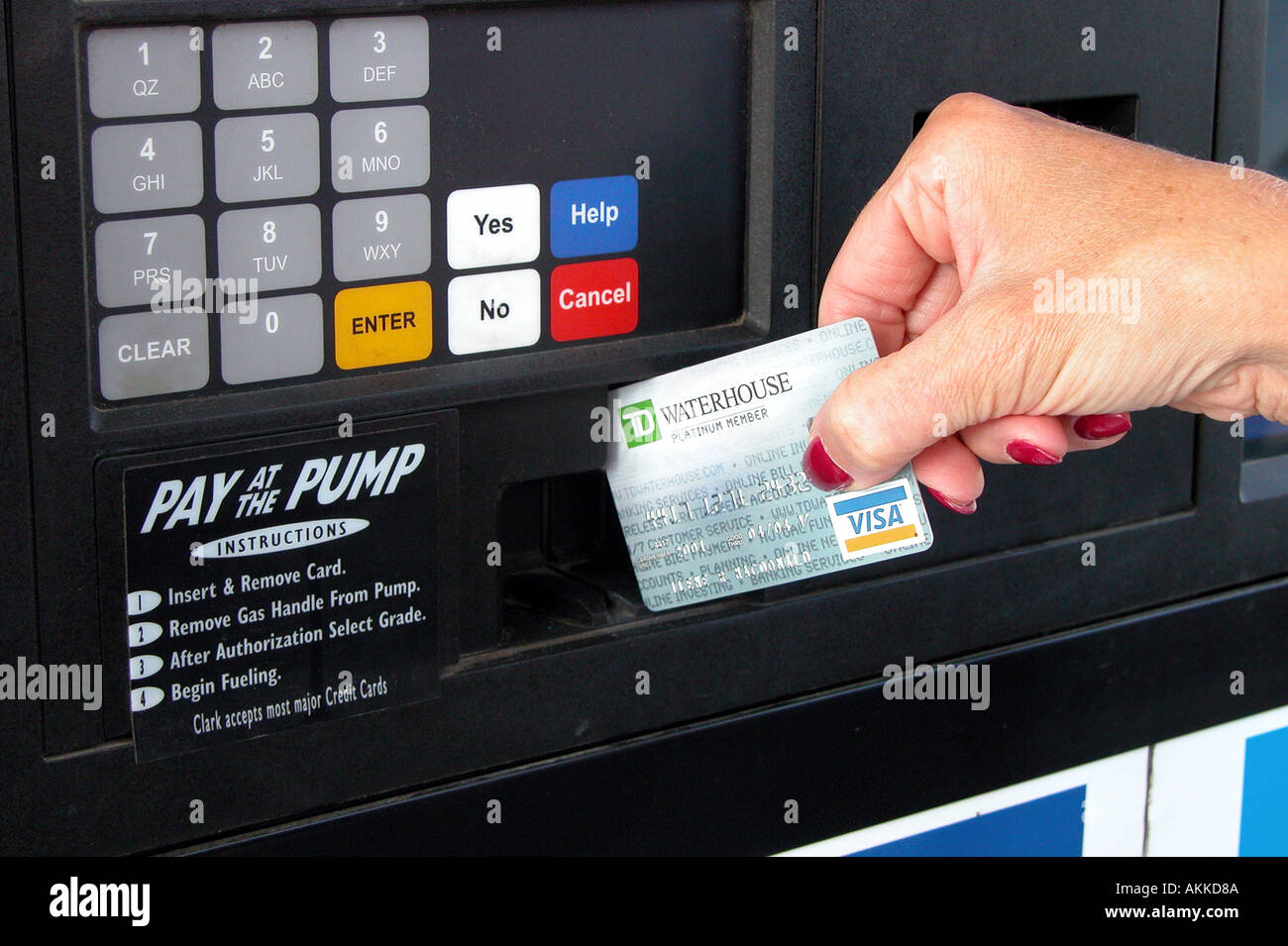 Female pays at the pump for gas at a self pay and pump gas station with ...