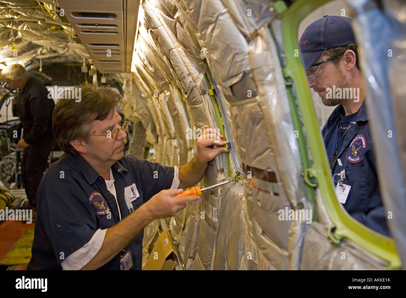 Workers do heavy maintenance on American Eagle Embraer jet airplanes at ...