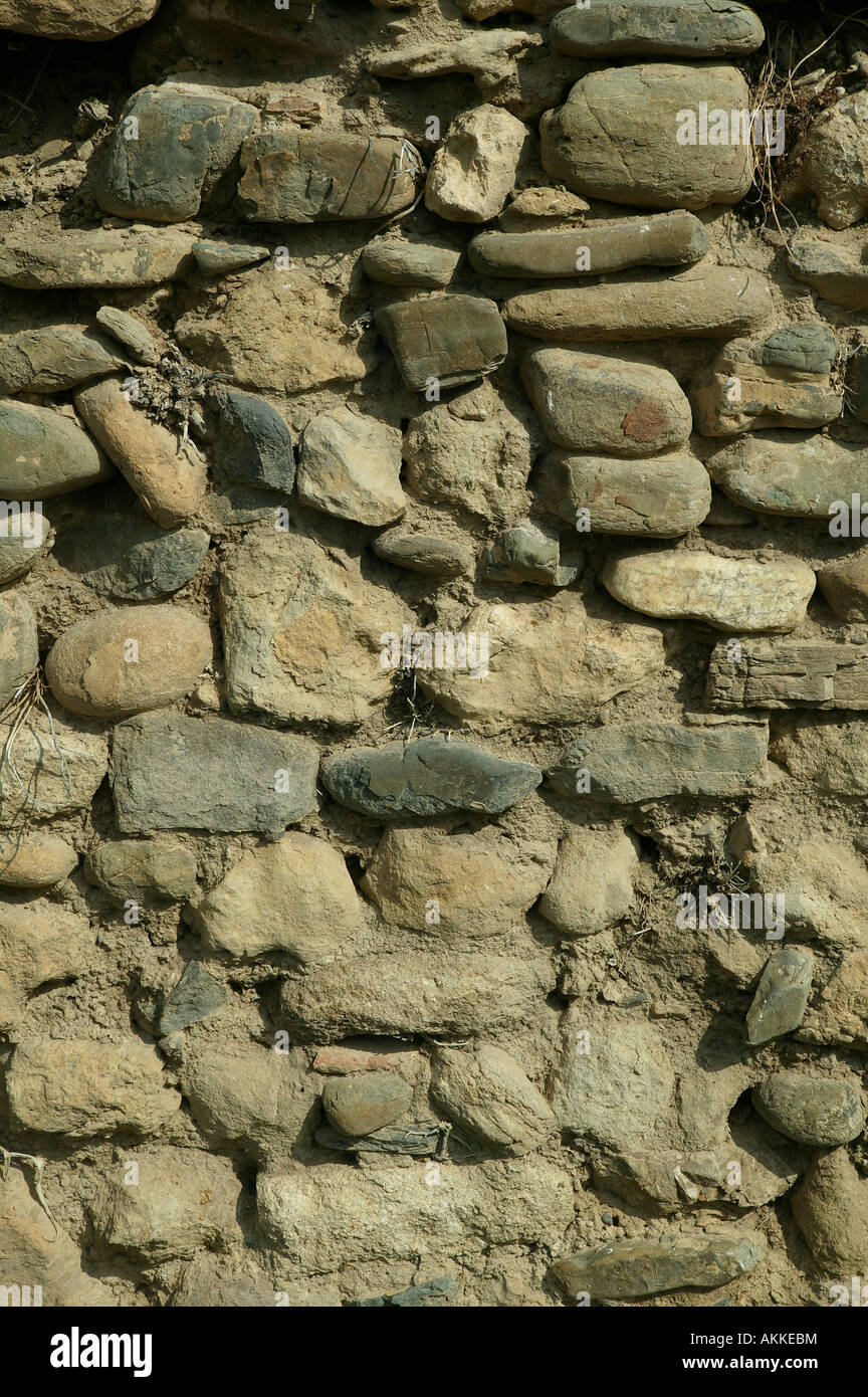 detail of stone wall with large round stones used in traditional old ...
