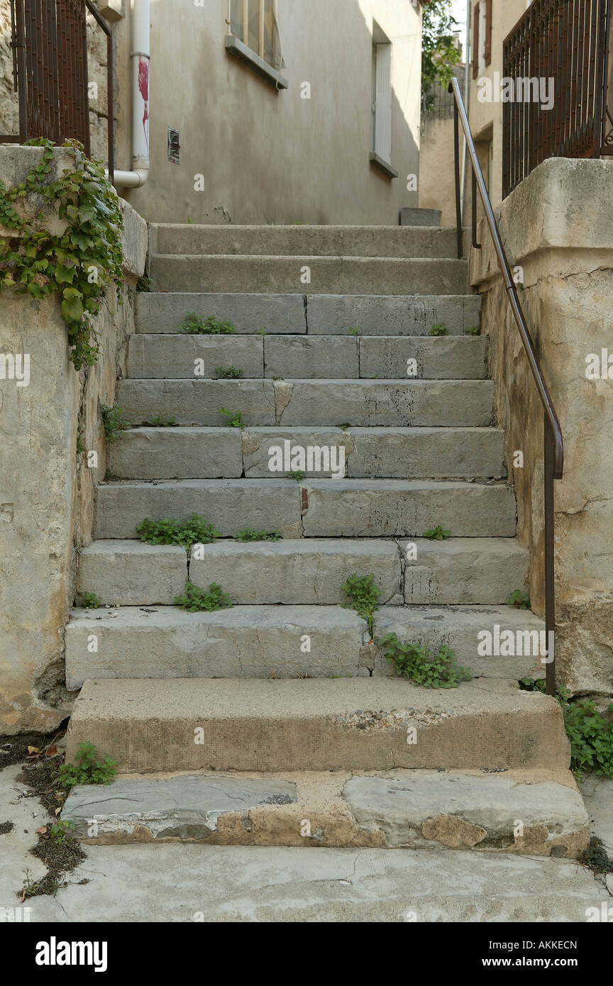 a set of steps in a close european village with concrete construction ...