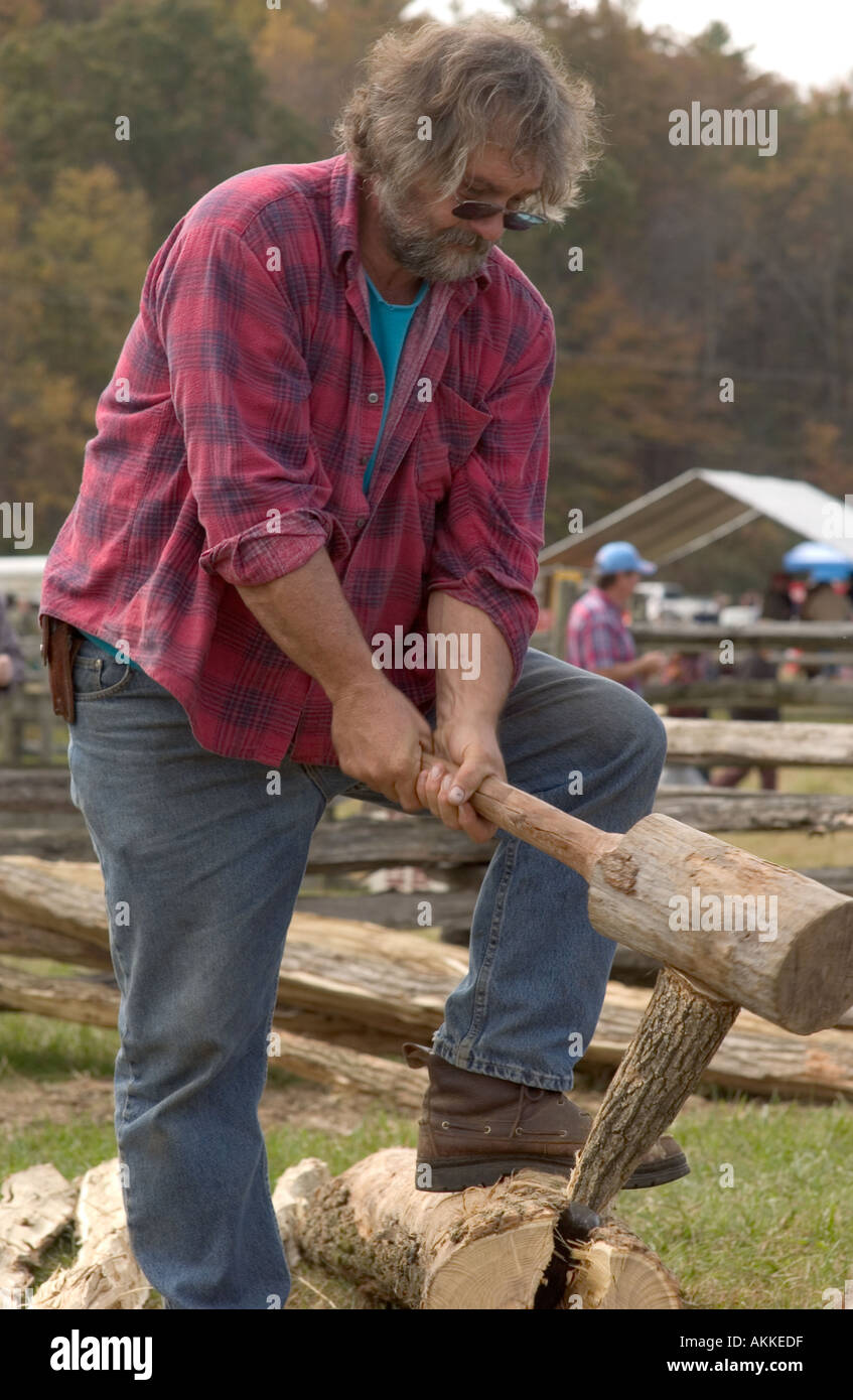 Man demonstrating how to build a split log fence at the Ferrum festival ...