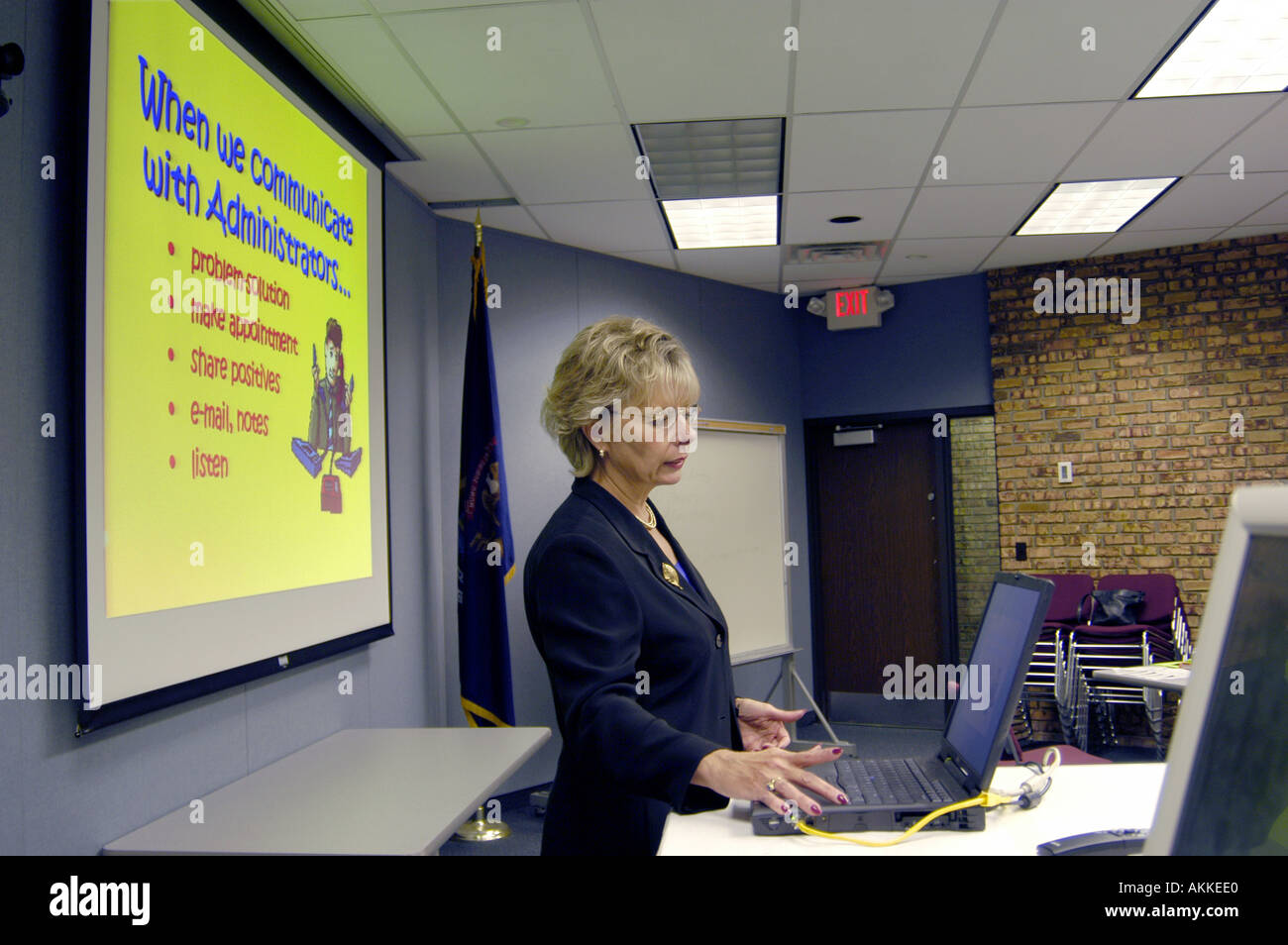 Female presenter gives Power Point presentation to a group of ...