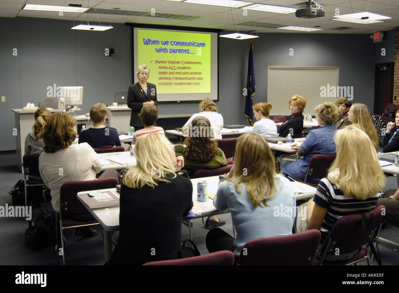 Female presenter gives Power Point presentation to a group of ...