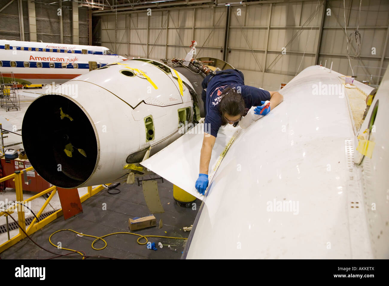 Workers do heavy maintenance on American Eagle Embraer jet airplanes at ...