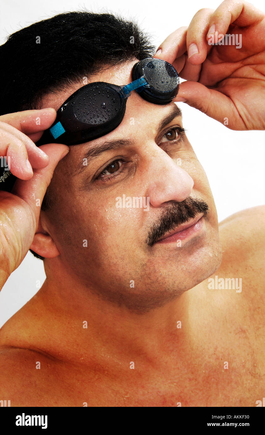 Man putting on swimming goggles Stock Photo - Alamy