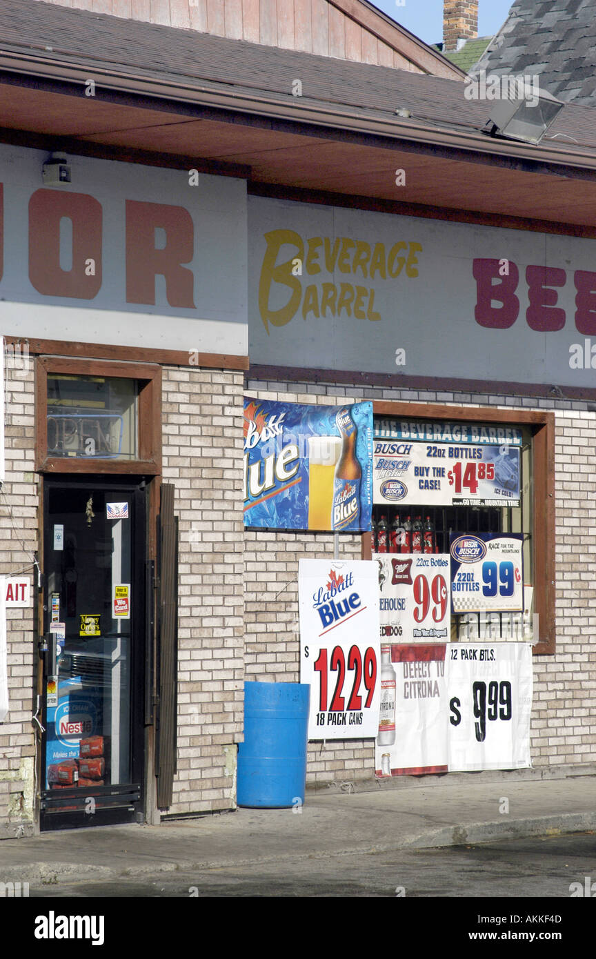 Many signs on side of party store exterior walls promoting BEER sales ...
